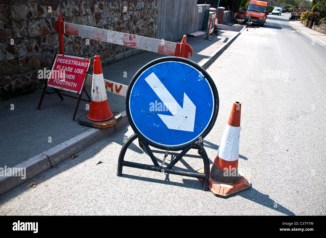 Pavement closed for repairs, with barrier, diversion notice, cones and ...