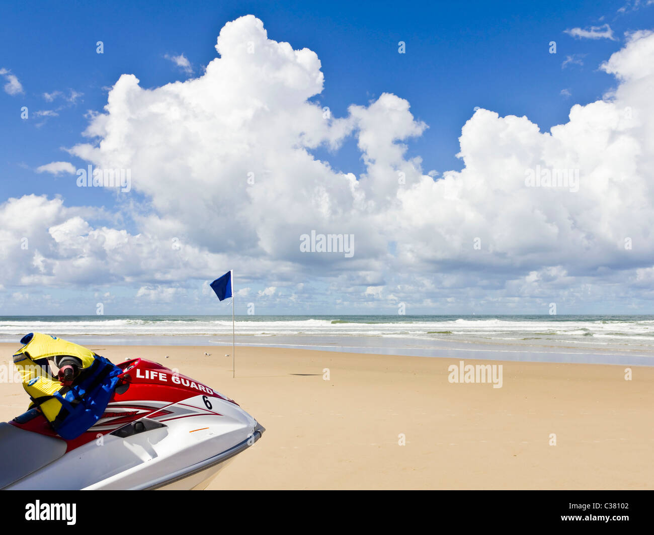 Beach lifeguard rescue boat on sand with waves and gathering storm ...