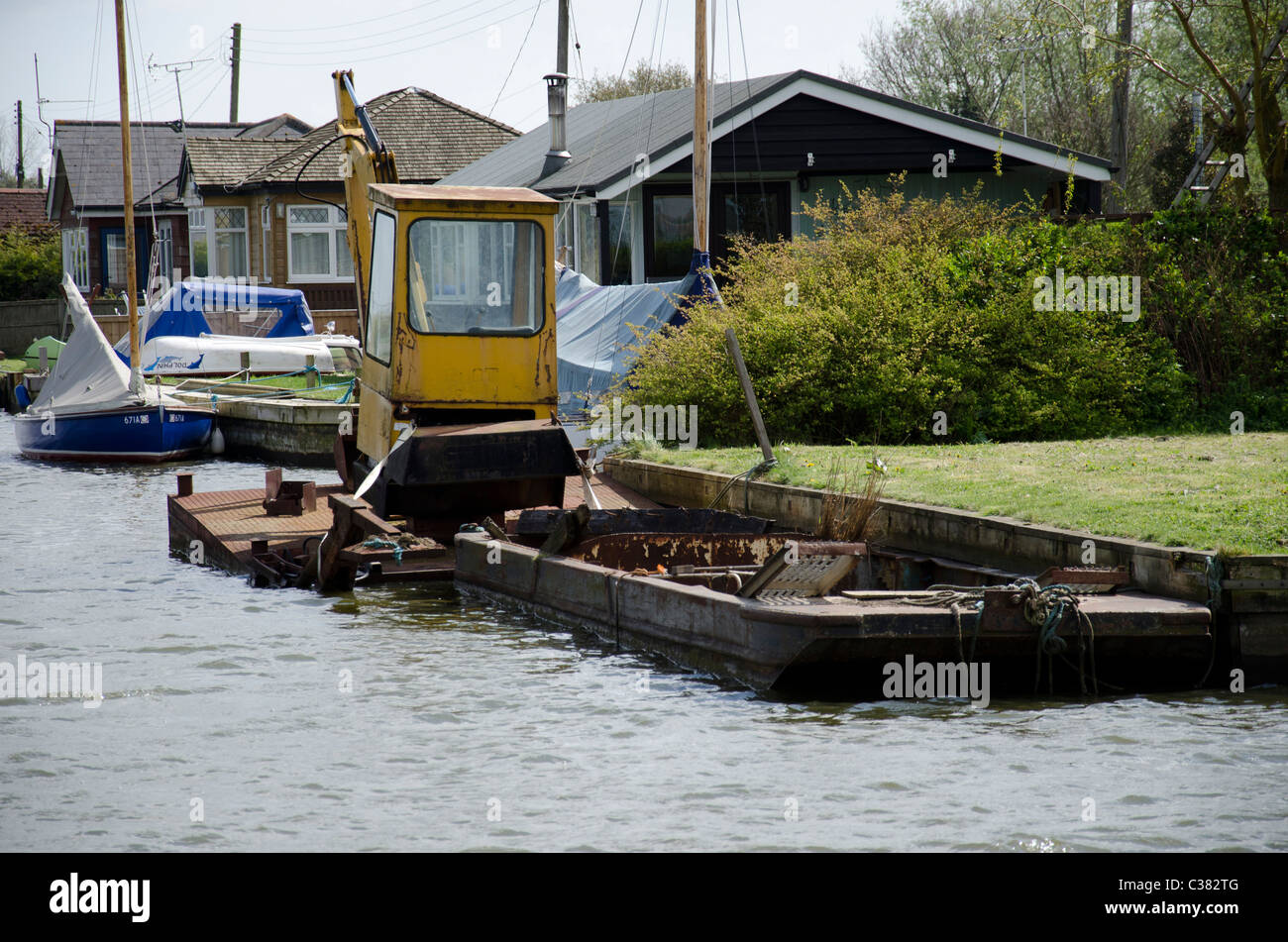 Floating mechanical digger on the River Thurne near Potter Heigham on ...