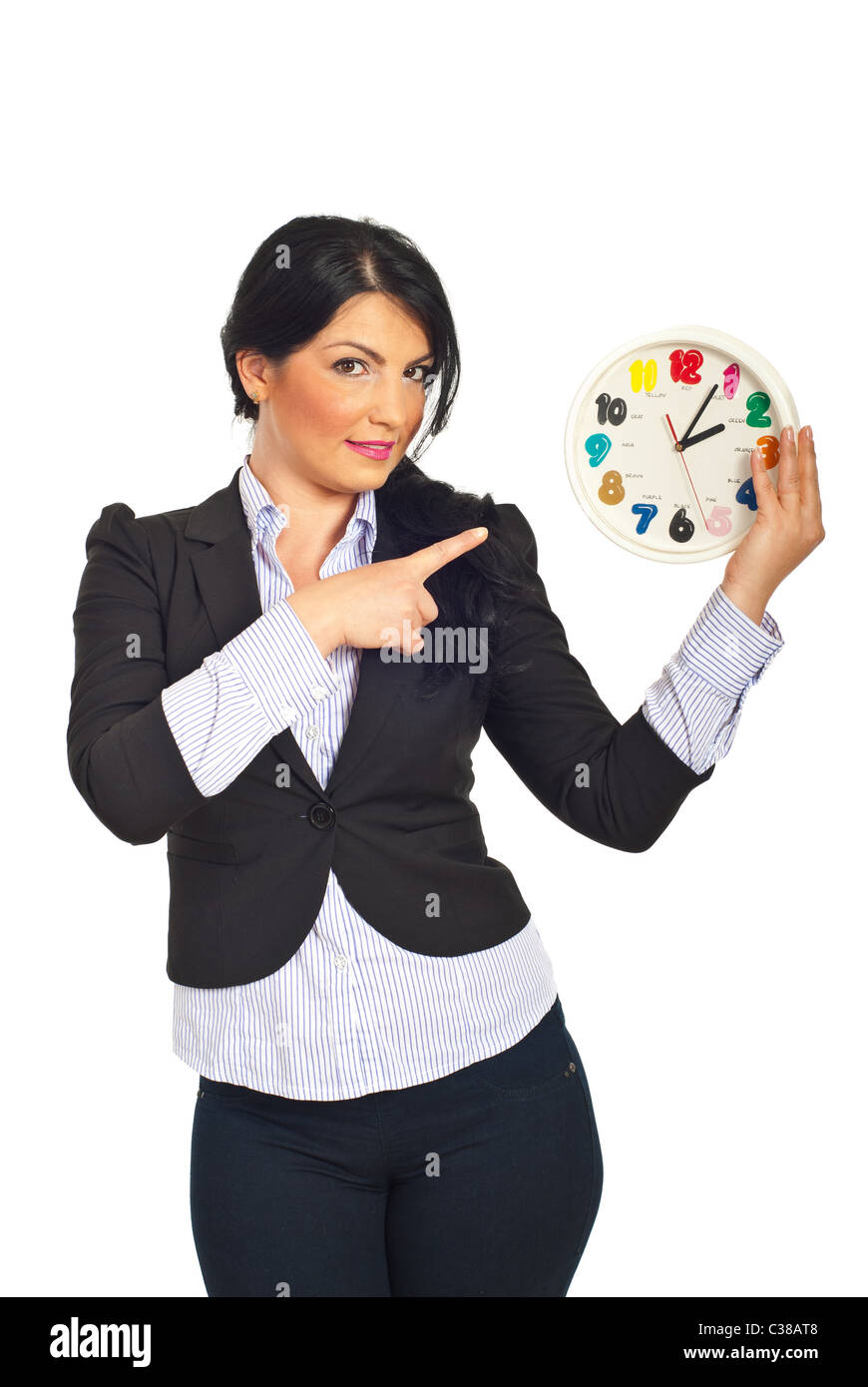 Smiling business woman holding and pointing to clock isolated on white ...