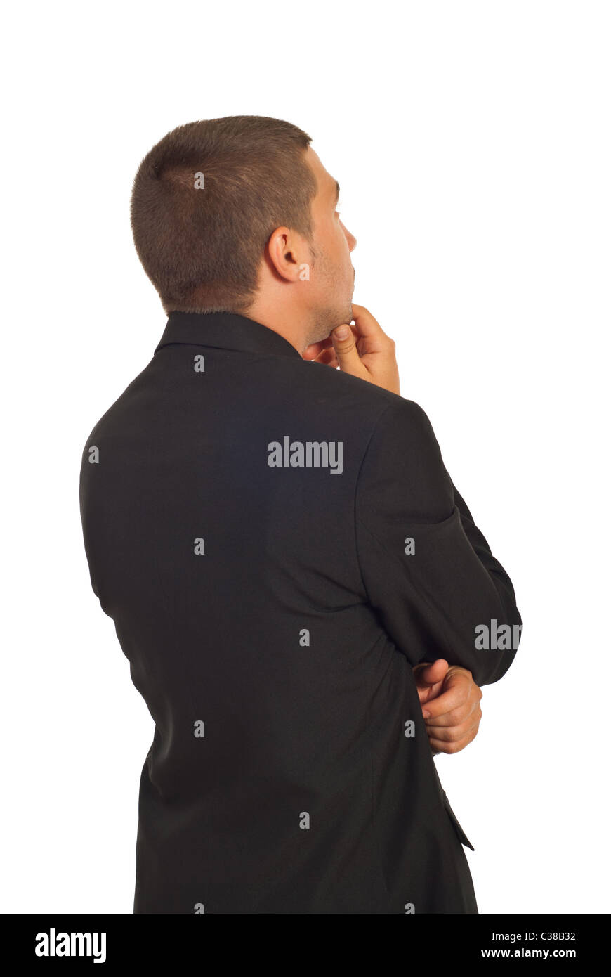 Back of young business man thinking and looking away isolated on white ...