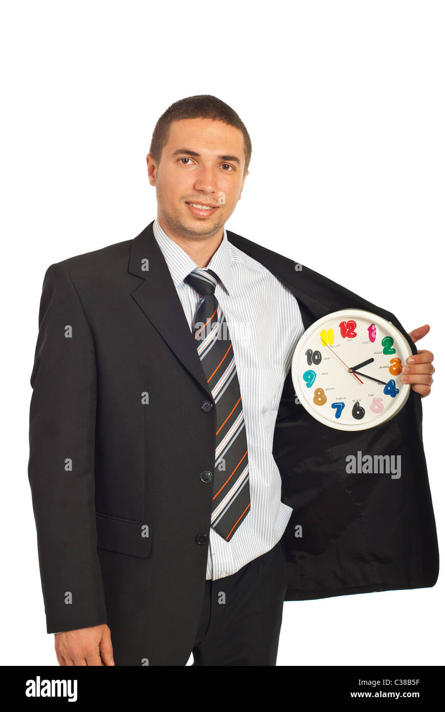 Smiling business man showing a clock in interior of his suit jacket ...
