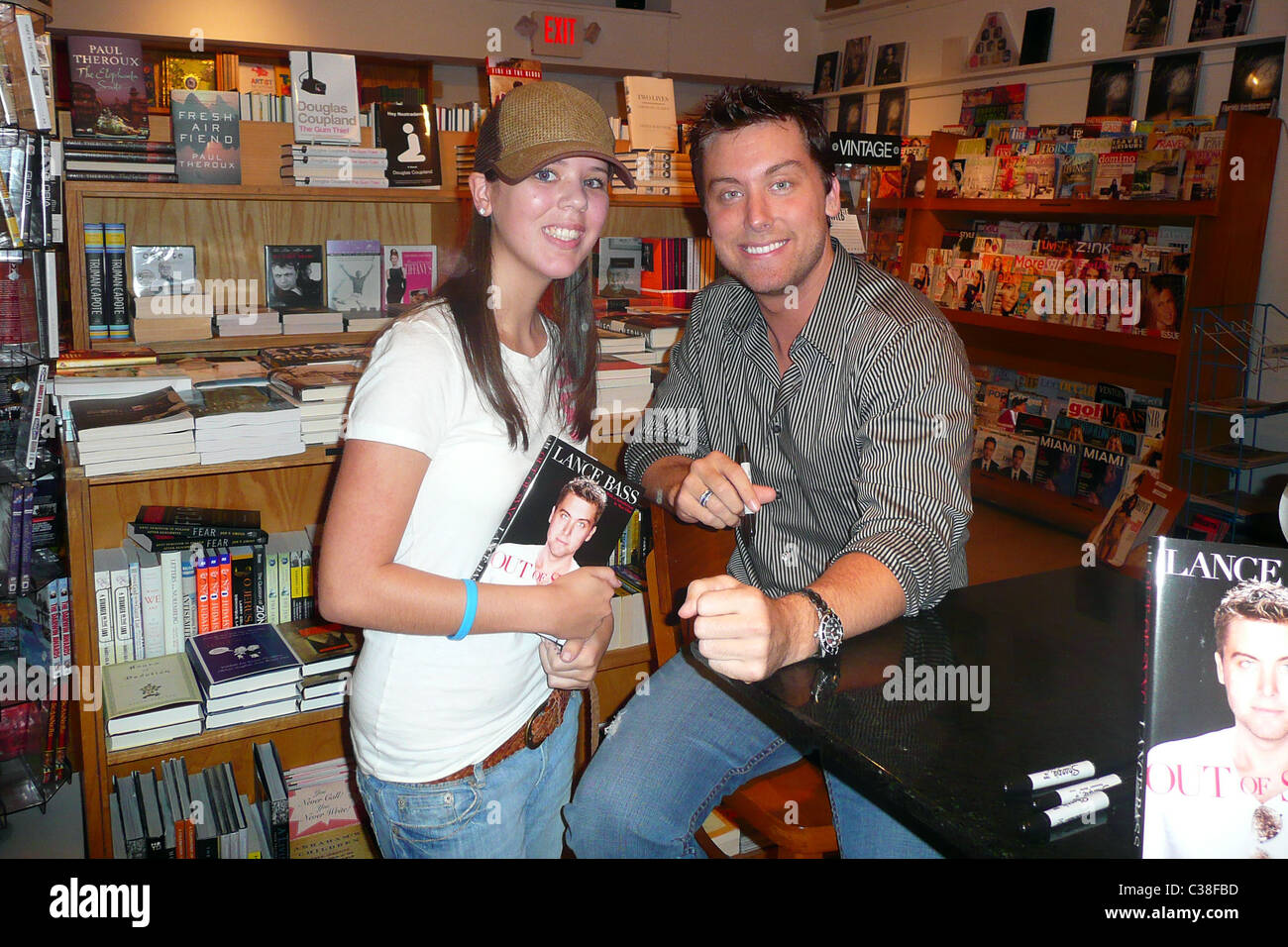 Lance Bass signs autographs and posses for photographs with a fan ...