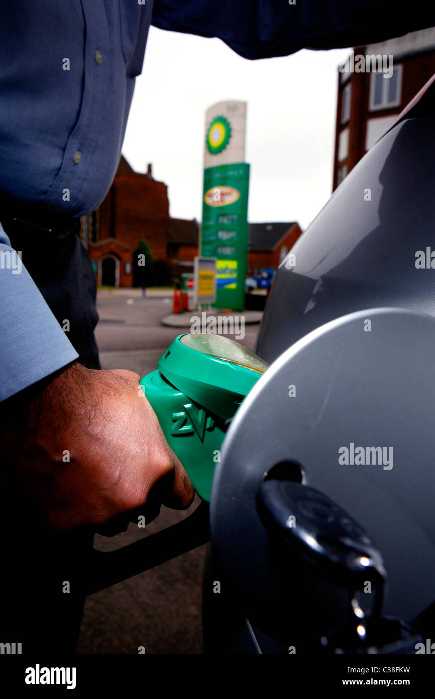 A man refueling his car at a BP petrol station Stock Photo - Alamy