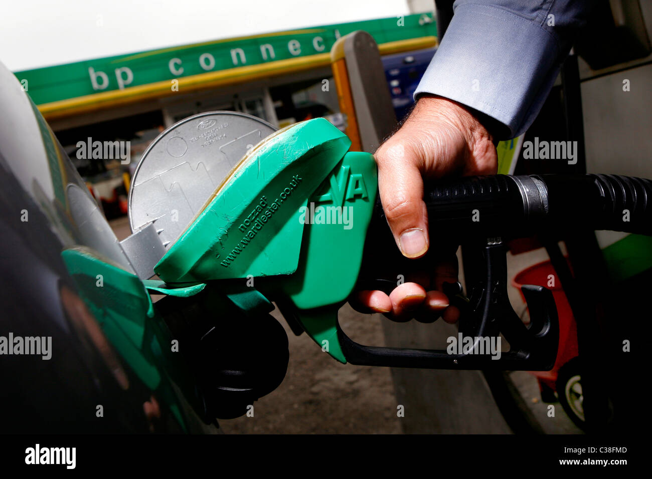 A man refueling his car at a BP petrol station Stock Photo - Alamy