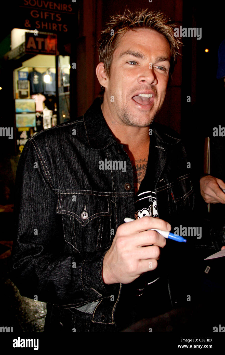 Mark McGrath of the band Sugar Ray signs autographs for fans outside ...