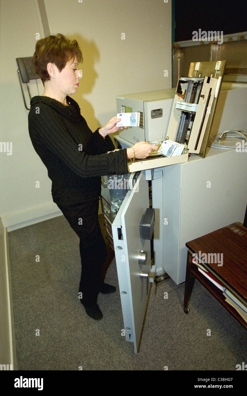 Paris: A Barclays Bank staff member loads an ATM with new euro notes in ...