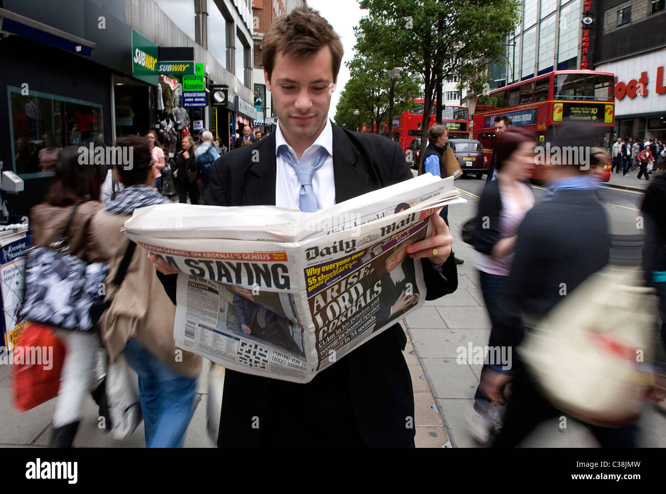 Daily Mail newspaper being read by man Stock Photo - Alamy