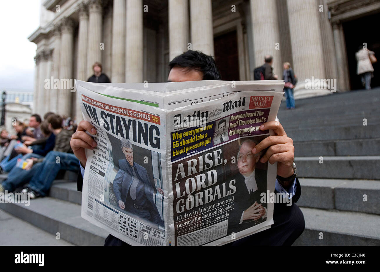 Daily Mail newspaper being read Stock Photo - Alamy