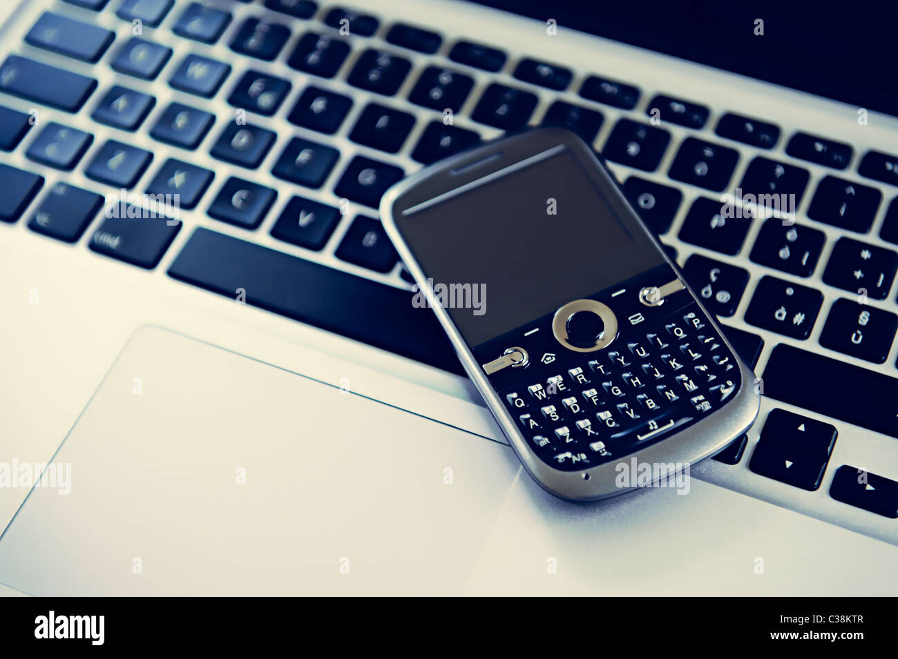 Mobile phone on a laptop. Communication concept, mobile internet ...