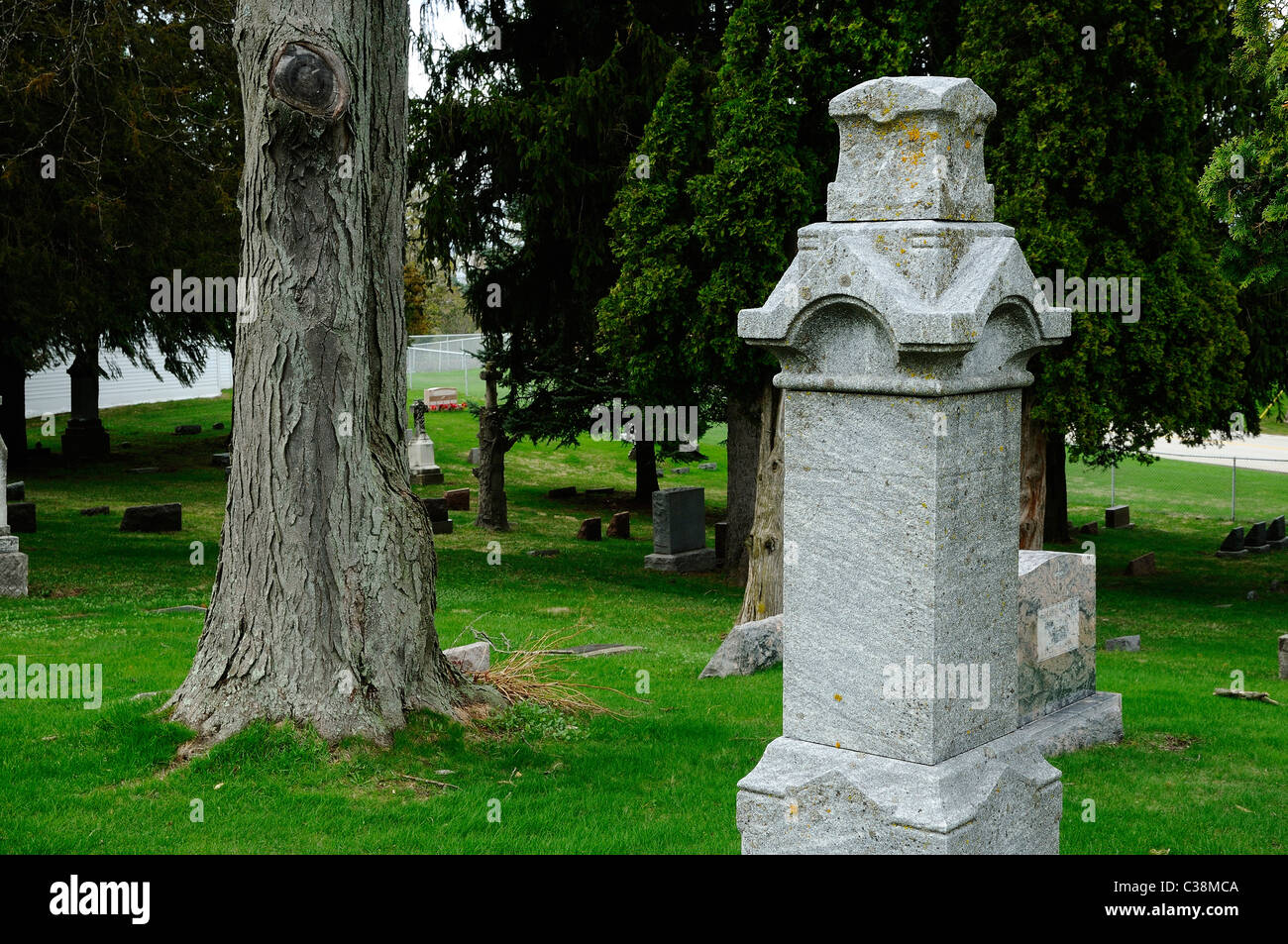 Small hillside cemetery with trees and gravestones Stock Photo - Alamy
