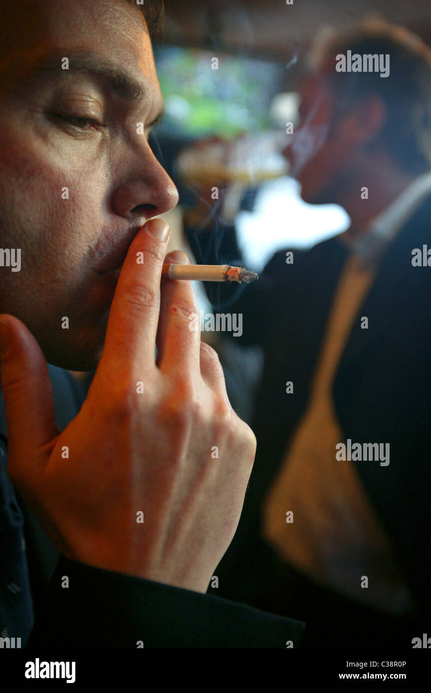 Men drink and smoking at a pub before the smoking ban Stock Photo - Alamy