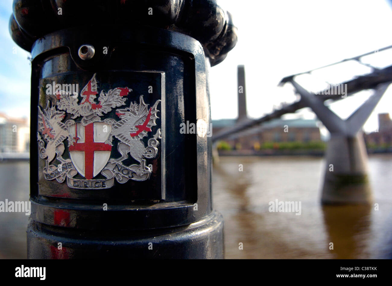 A city of London sign on a lamp post with the Millenium Bridge Stock ...