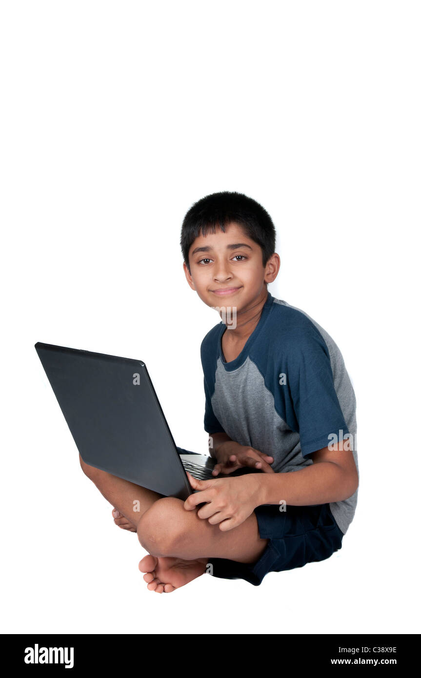 An handsome Indian kid having fun with laptop Stock Photo - Alamy