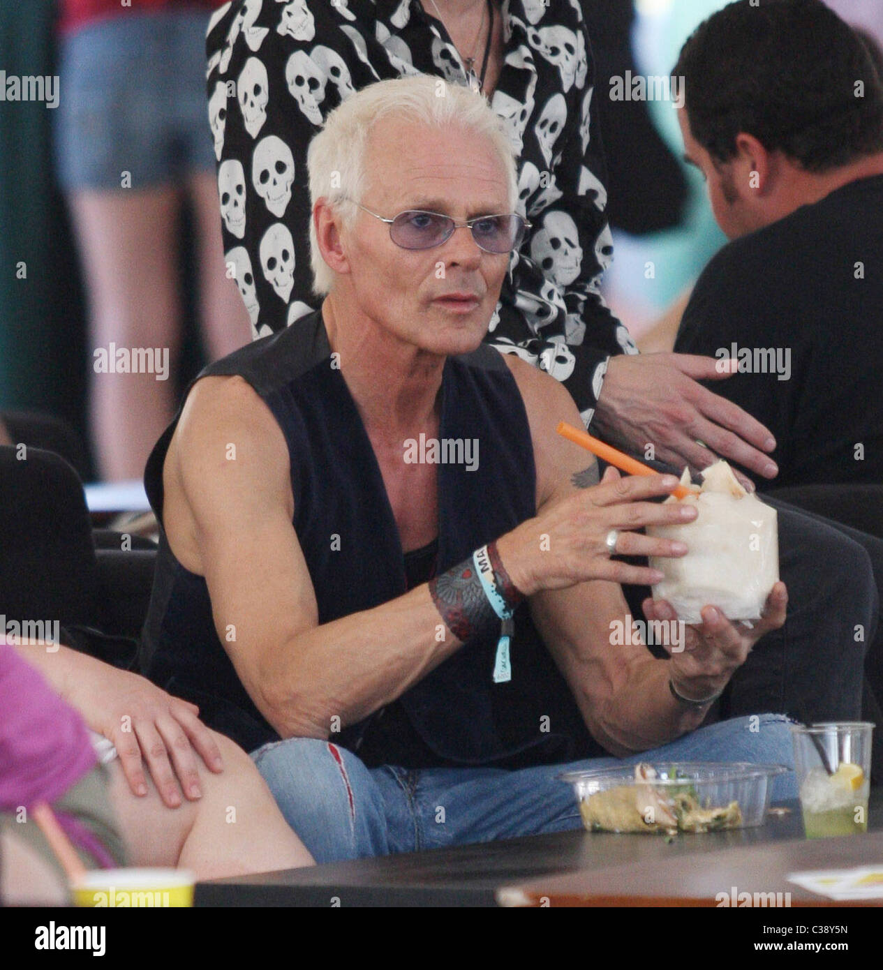 Michael Des Barres drinks from a coconut while relaxing at Coachella ...