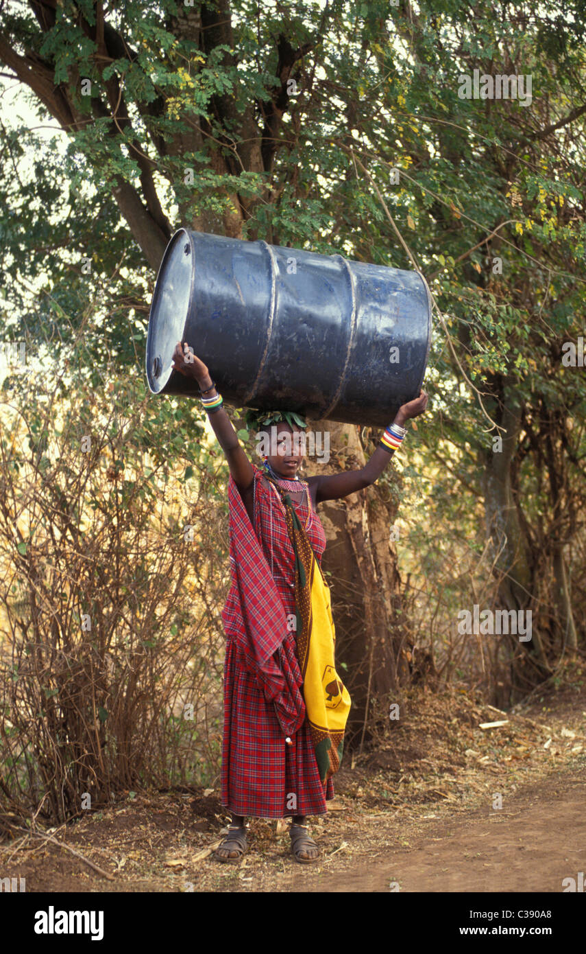 Tanzania. Woman with a water barrel Stock Photo - Alamy
