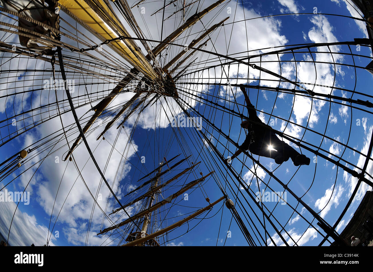 A crew member climbs the rigging on the Danish tall ship Georg Stage as ...