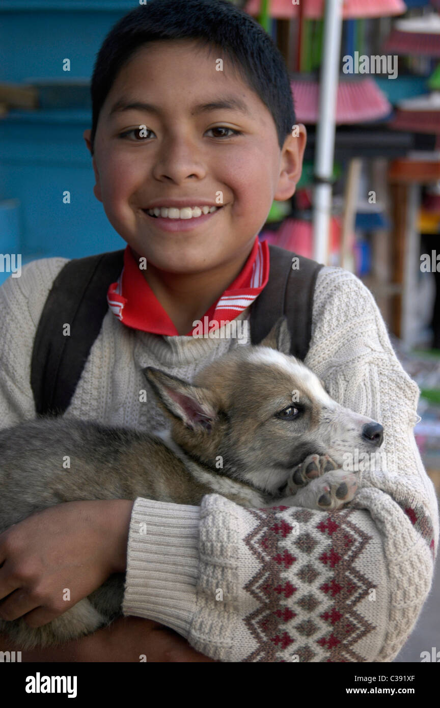 Bolivia. Boy in Oruro town with his pet dog Stock Photo - Alamy