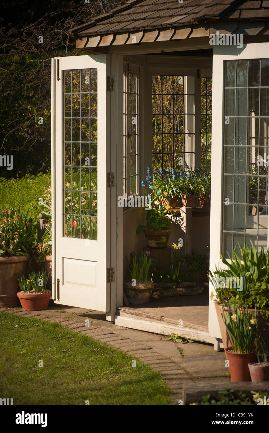Octagonal shaped summer house with double doors wide open on a sunny ...
