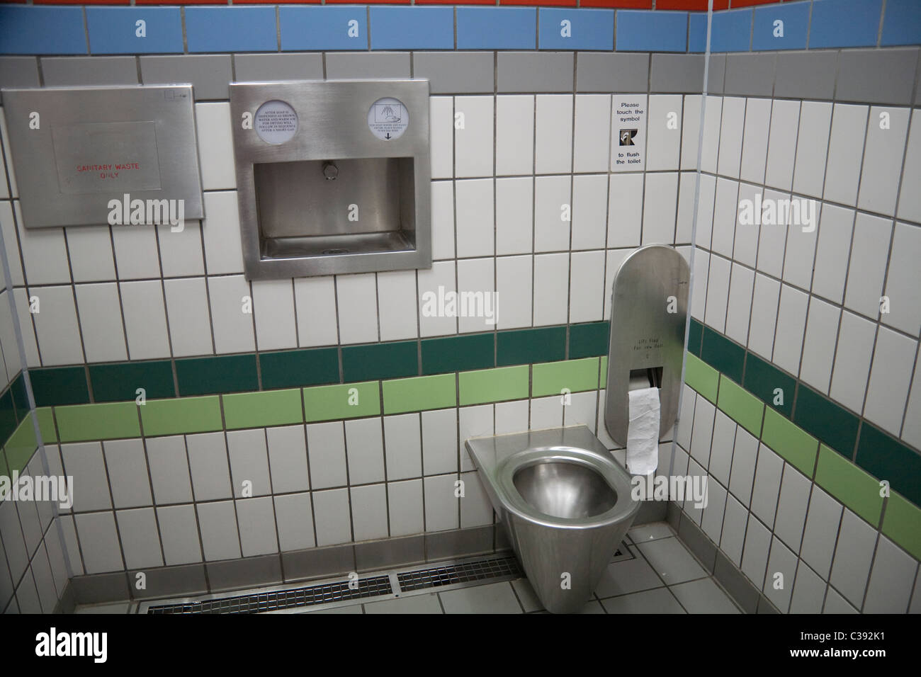 UK Inside grey and green tiled public toilet with stainless steel ...
