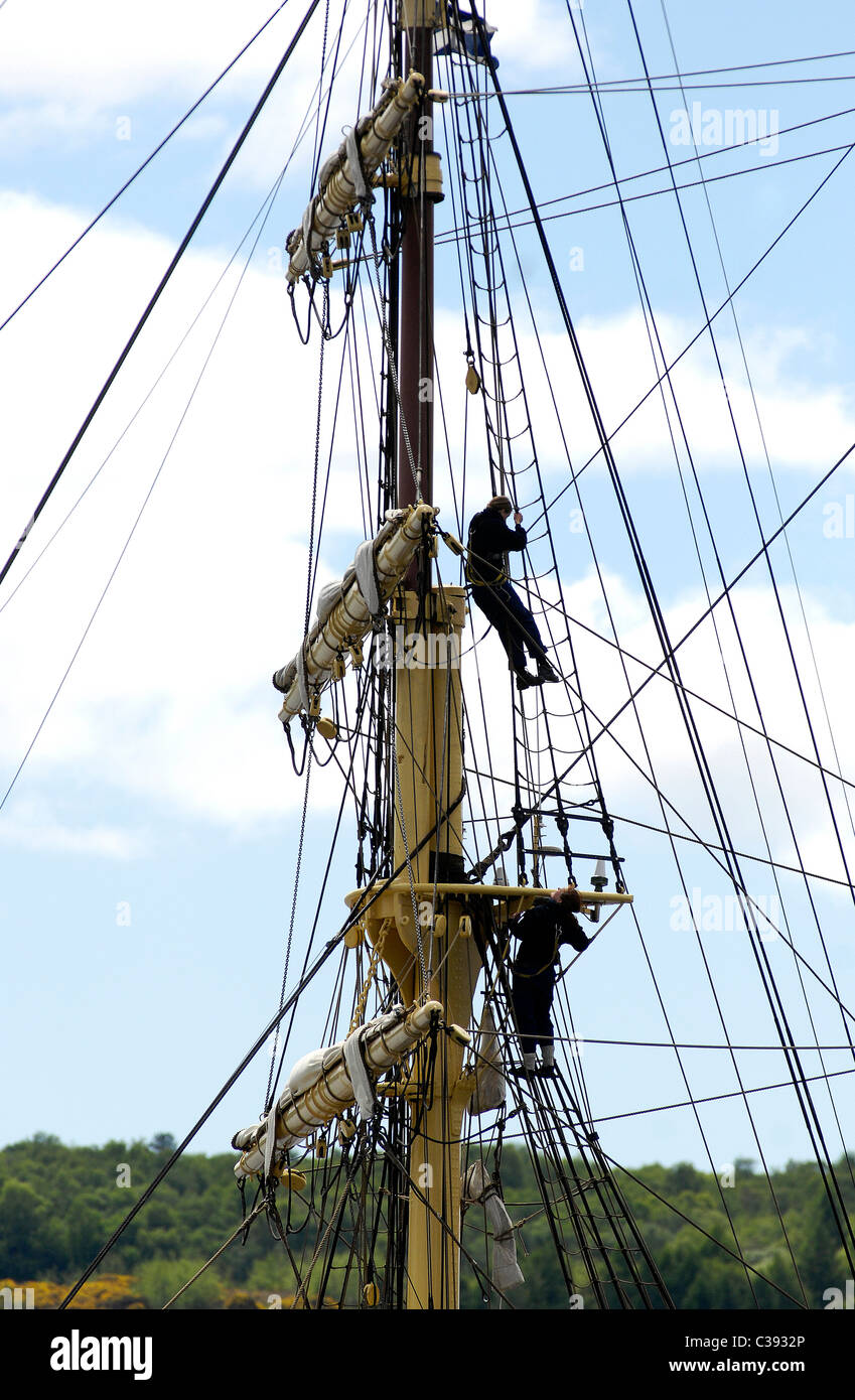 A crew member climbs the rigging on the Danish tall ship Georg Stage as ...