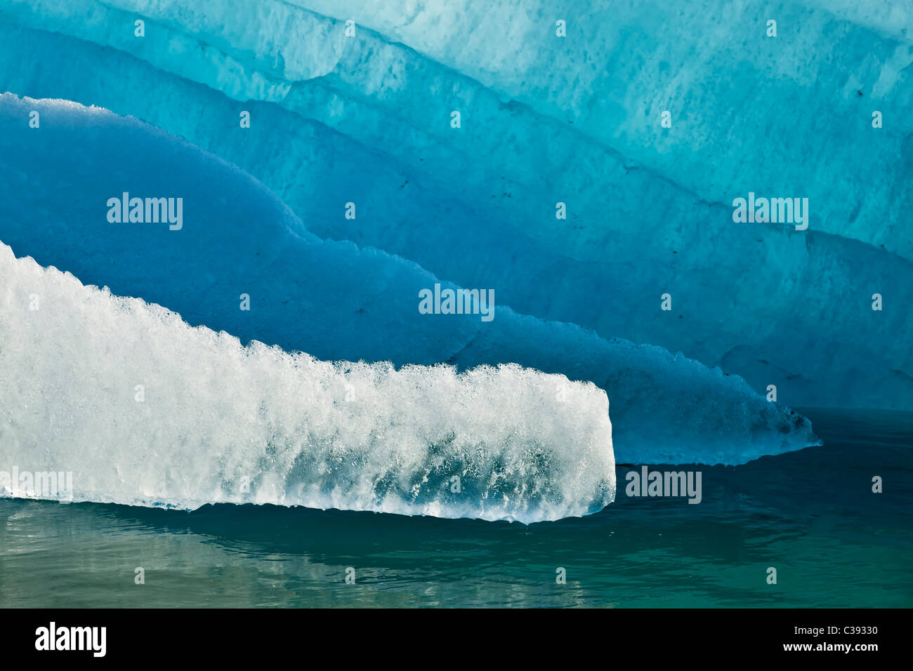 Layers/color changes indicate stages of melting on this iceberg from ...