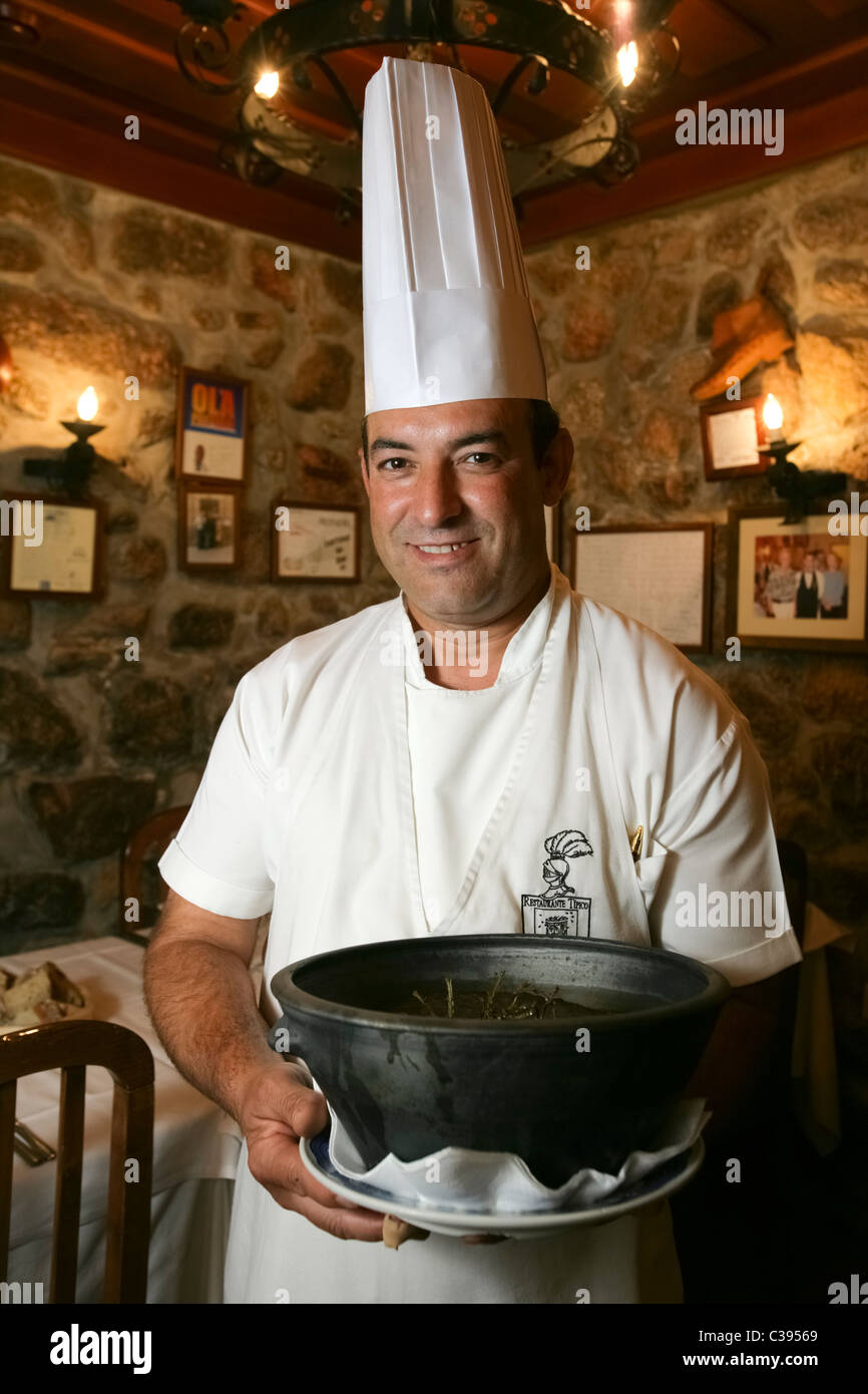 Portrait of chef holding food casserole in a restaurant Stock Photo - Alamy