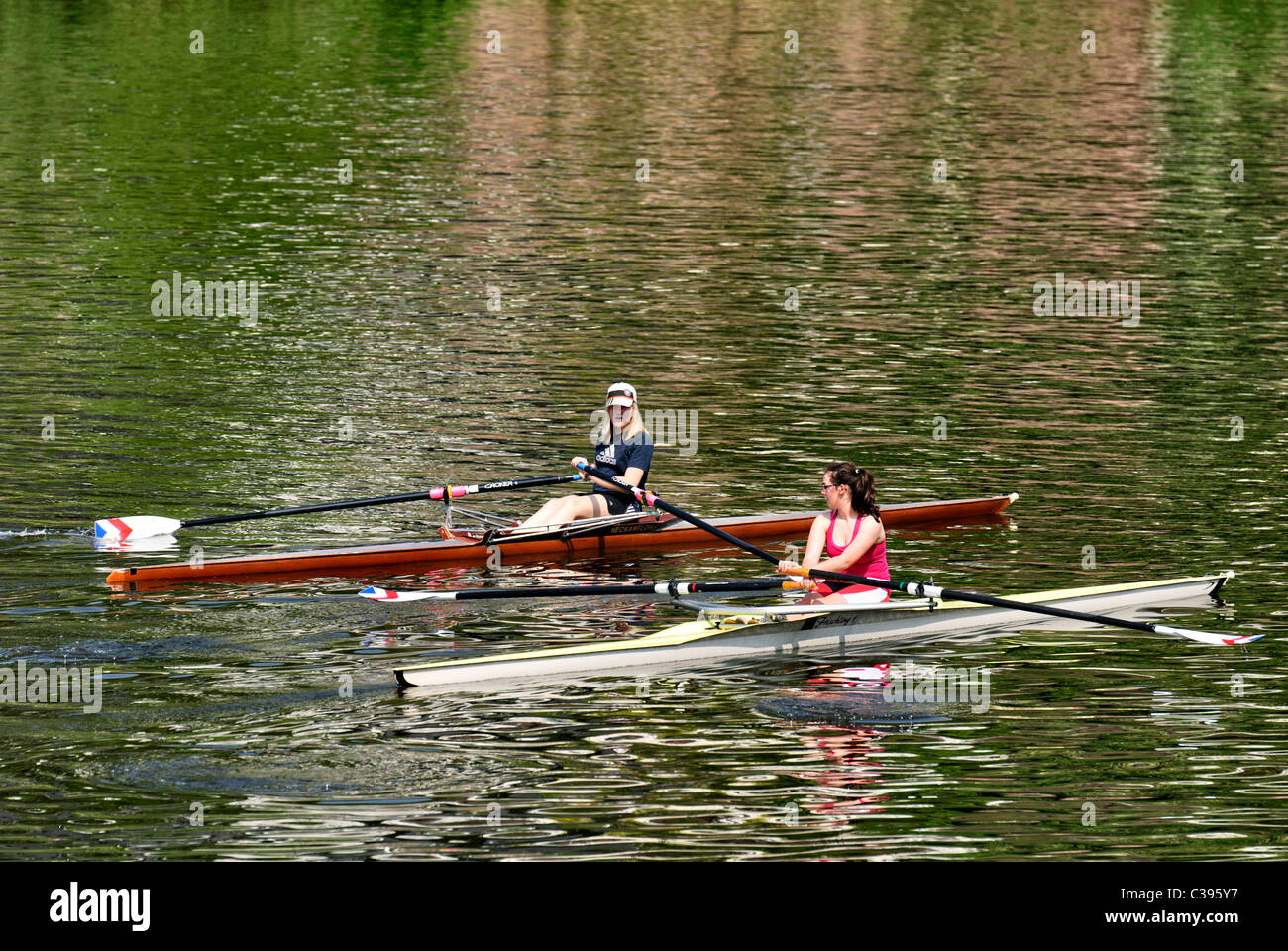 Two young woman single rowing skiff on river Neckar, Heidelberg Stock ...