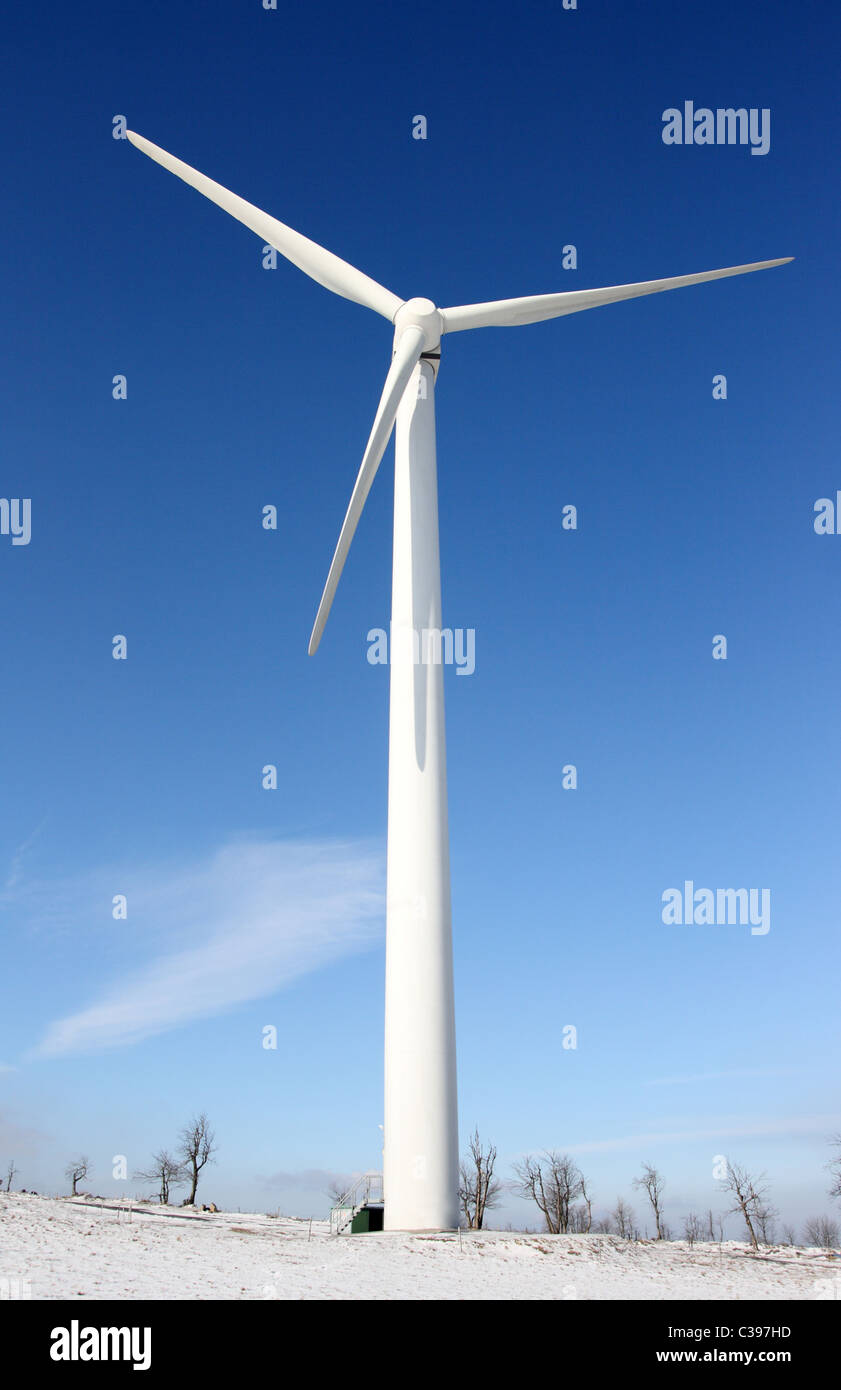 View of single windmill generating electricity against blue sky in a ...