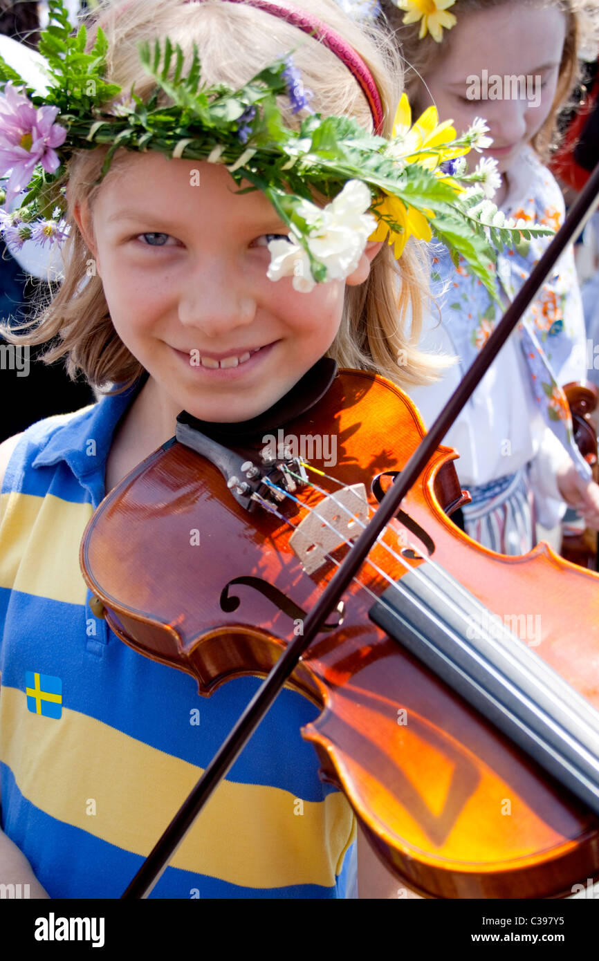 Cute young girl playing the violin for Midsommar Celebration at the ...