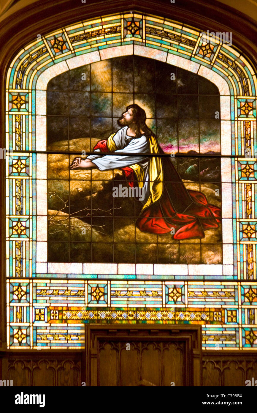 Stain glass window of Christ praying in the garden of Gethsemane in the ...
