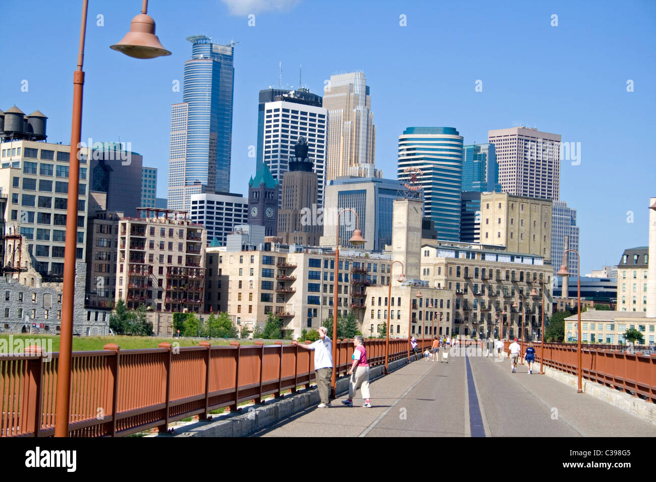 Walkway on the Stone Arch Bridge with a view of downtown Minneapolis ...