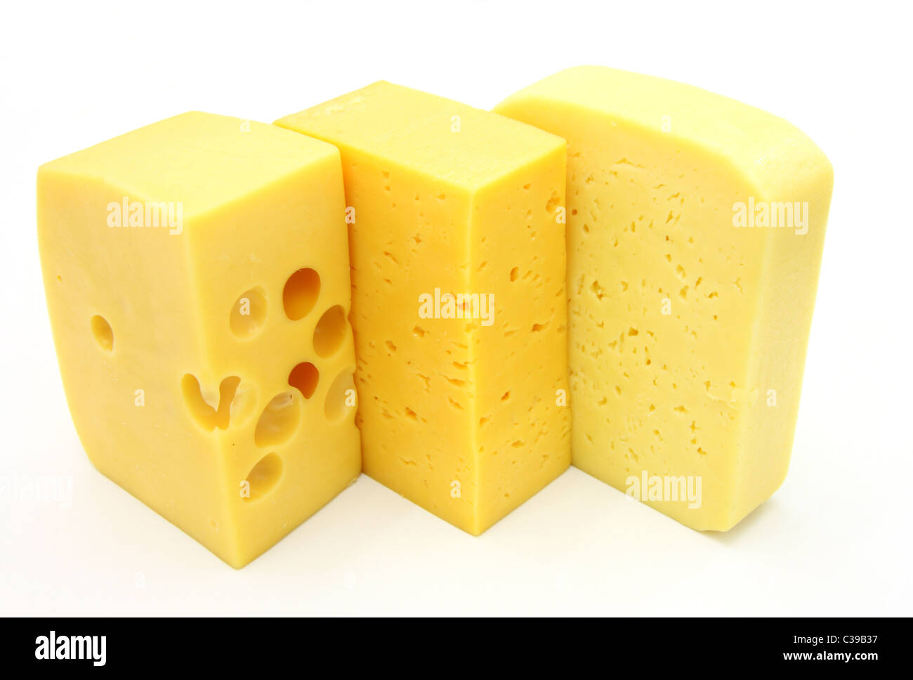 three pieces of different kinds of cheese isolated on a white ...