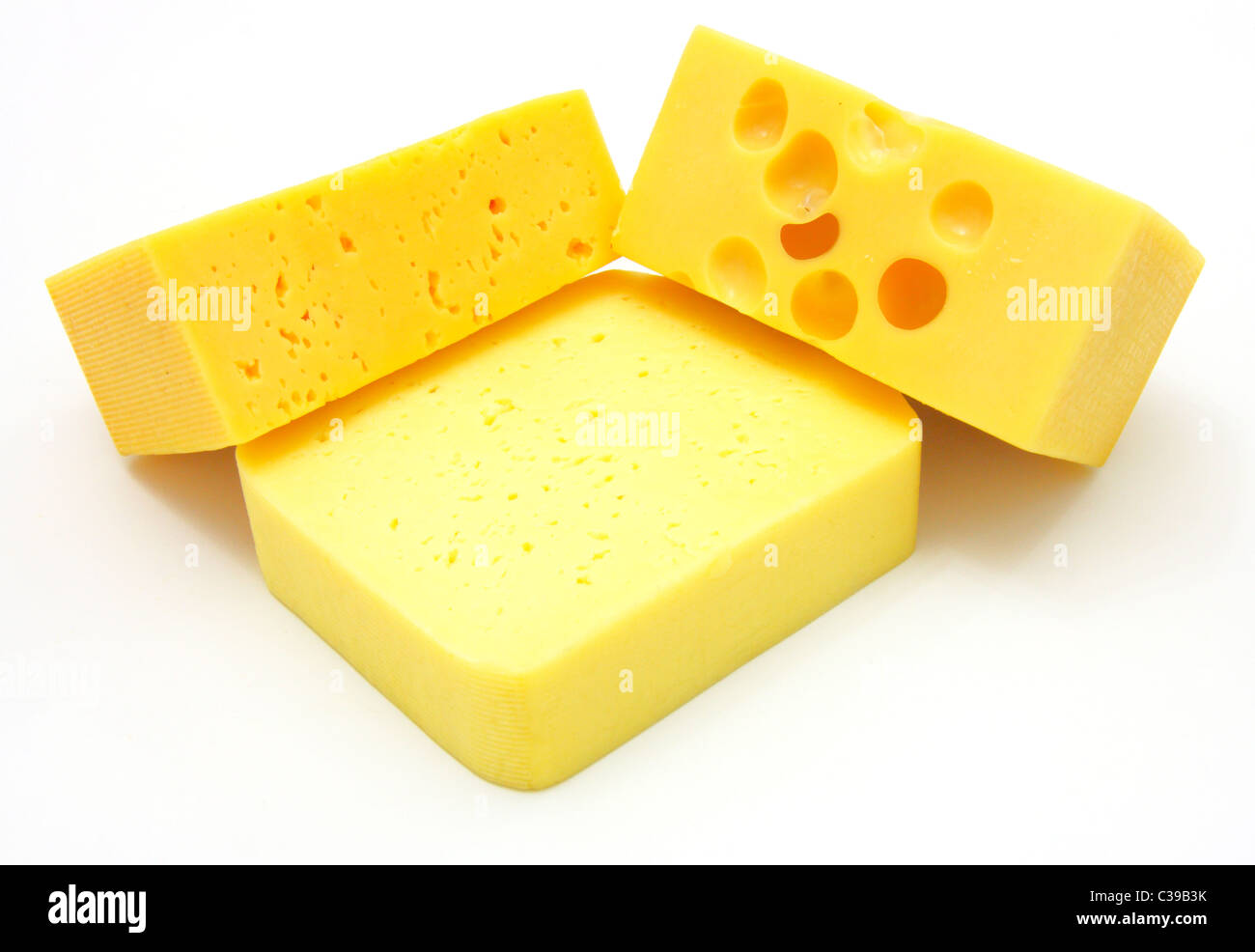 three pieces of different kinds of cheese isolated on a white ...