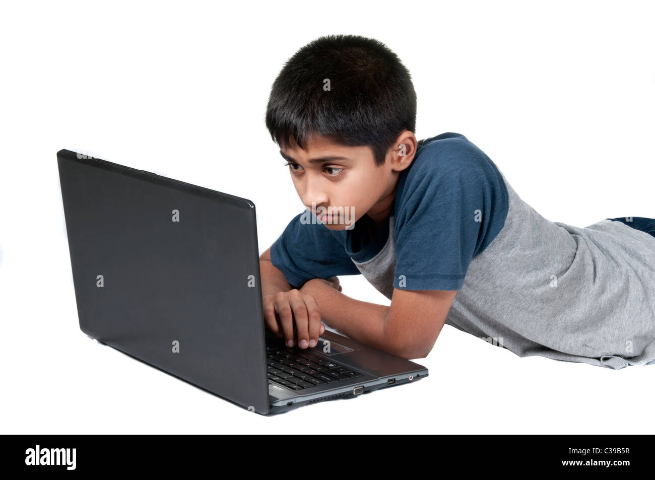 An handsome Indian kid having fun with laptop Stock Photo - Alamy