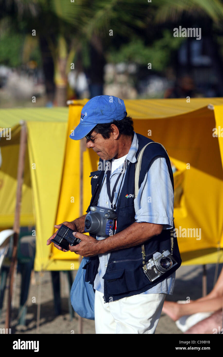 Photographer with his collection of cameras on the beach at Bocagrande ...