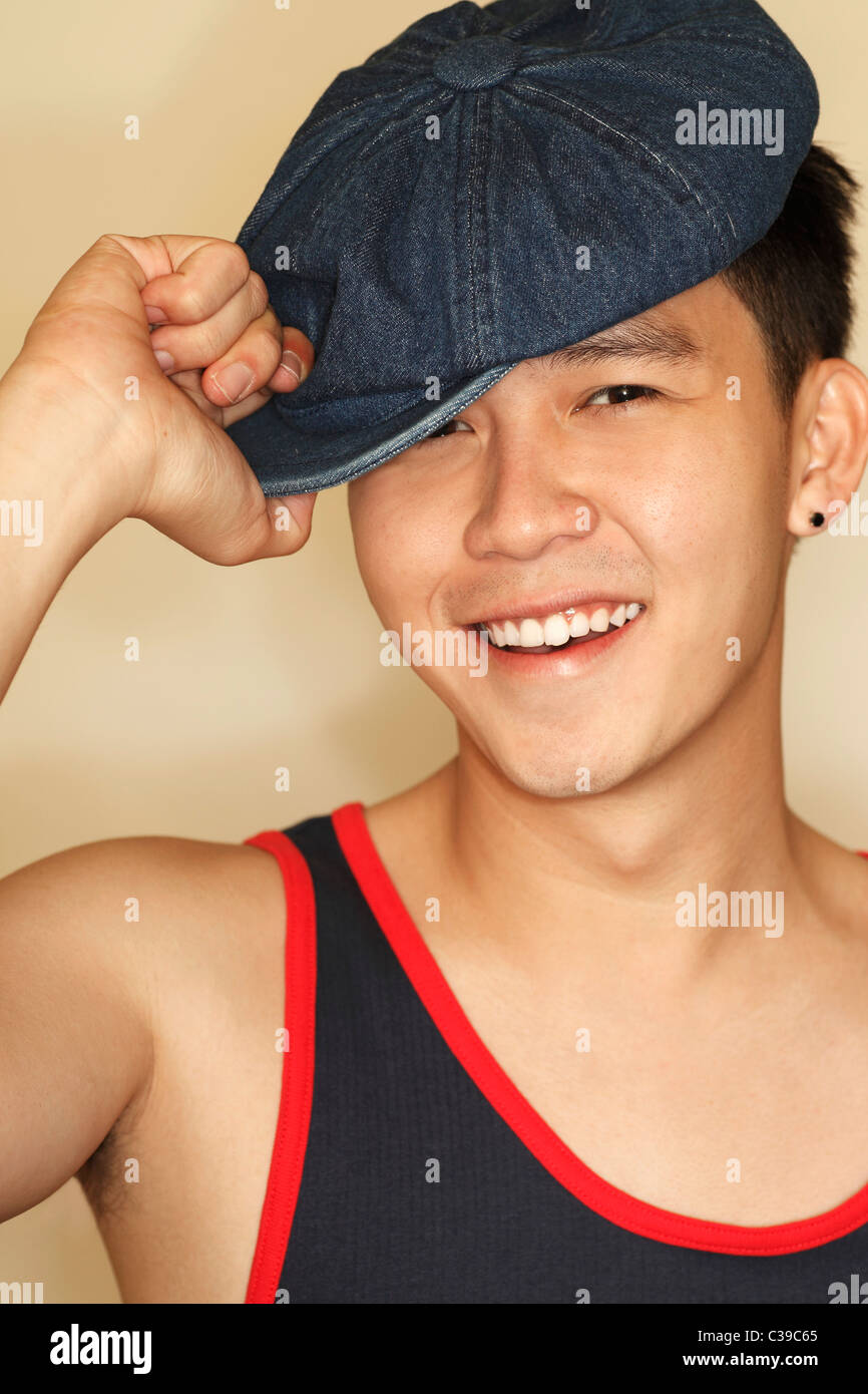 Head shot of Chinese man holding hat and smiling Stock Photo - Alamy