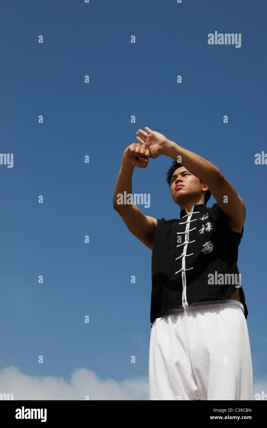 Chinese man putting hands together in greeting Stock Photo - Alamy