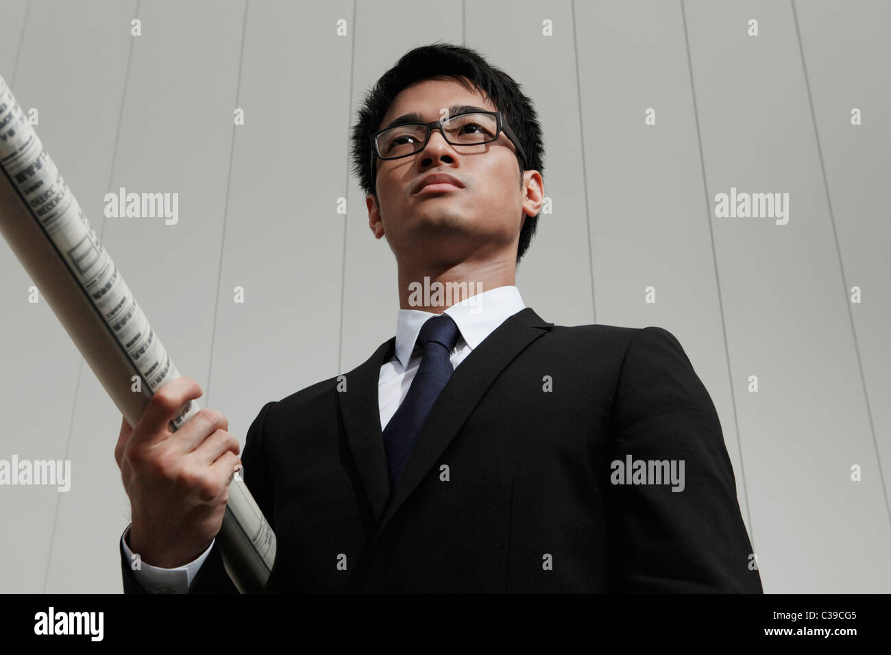 Chinese man holding building plans Stock Photo - Alamy