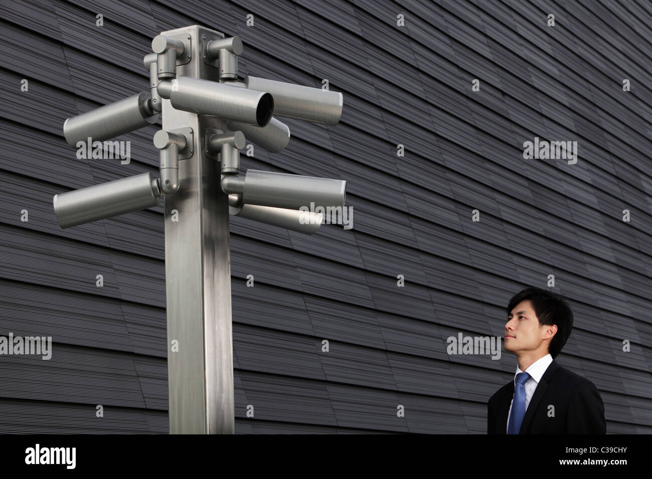 Man looking at surveillance cameras Stock Photo - Alamy