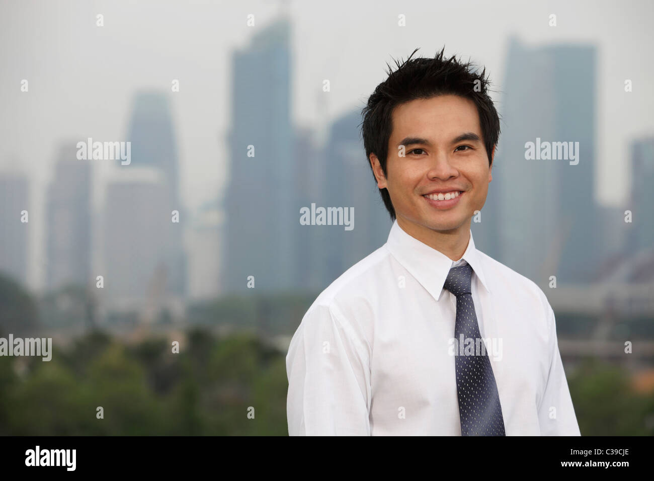 Chinese man standing in front of city skyline Stock Photo - Alamy