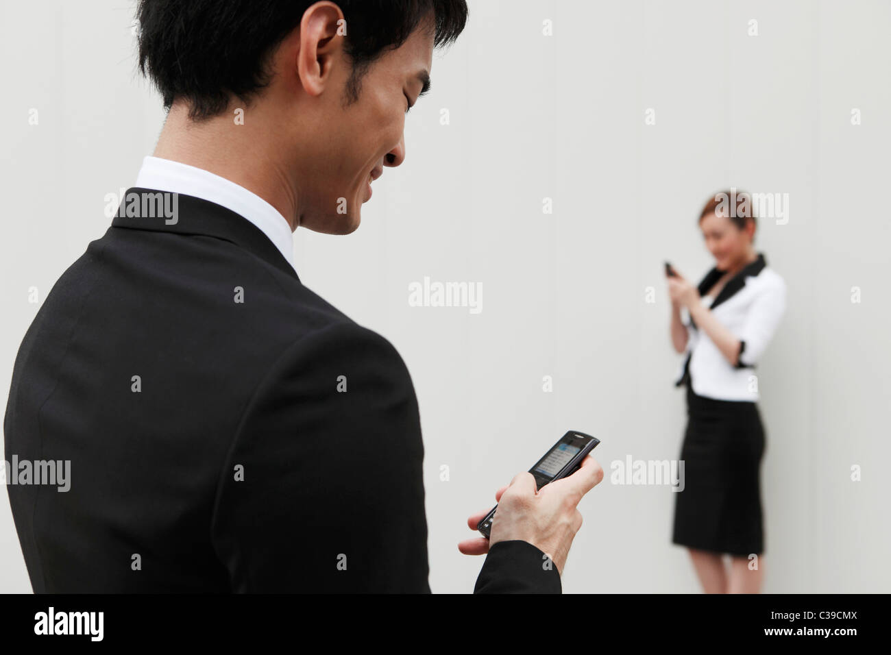 Chinese man texting woman with hand phone Stock Photo - Alamy