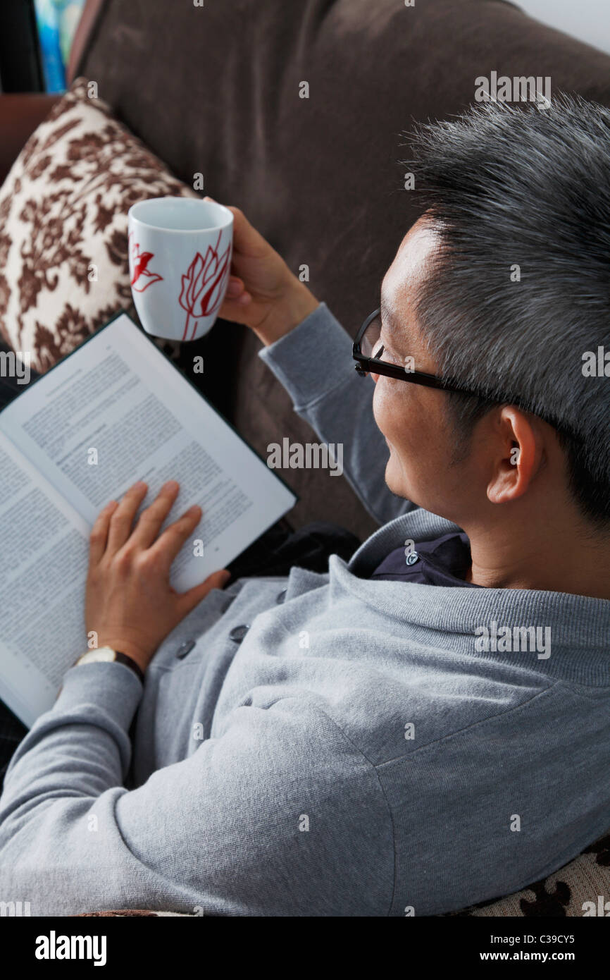 Man reading book at home 40 44 years hi-res stock photography and ...
