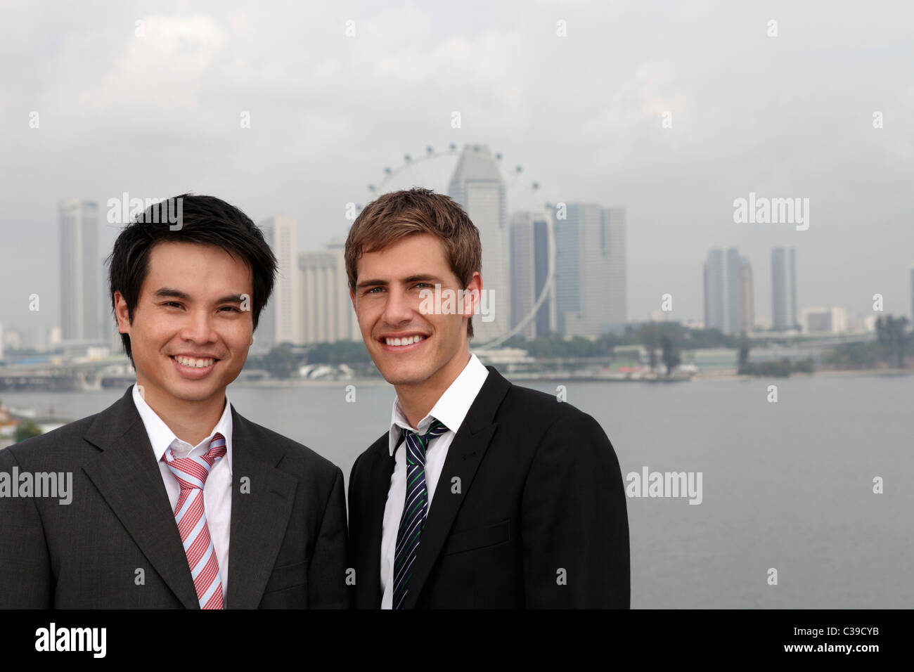 Chinese and Caucasian man standing in front of city skyline Stock Photo ...