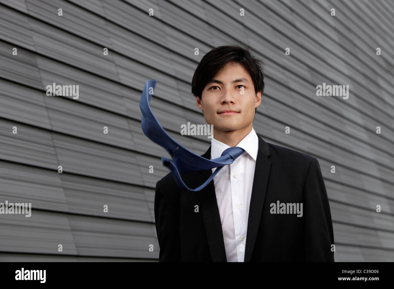 Chinese man wearing a suit with tie blowing in the wind Stock Photo - Alamy