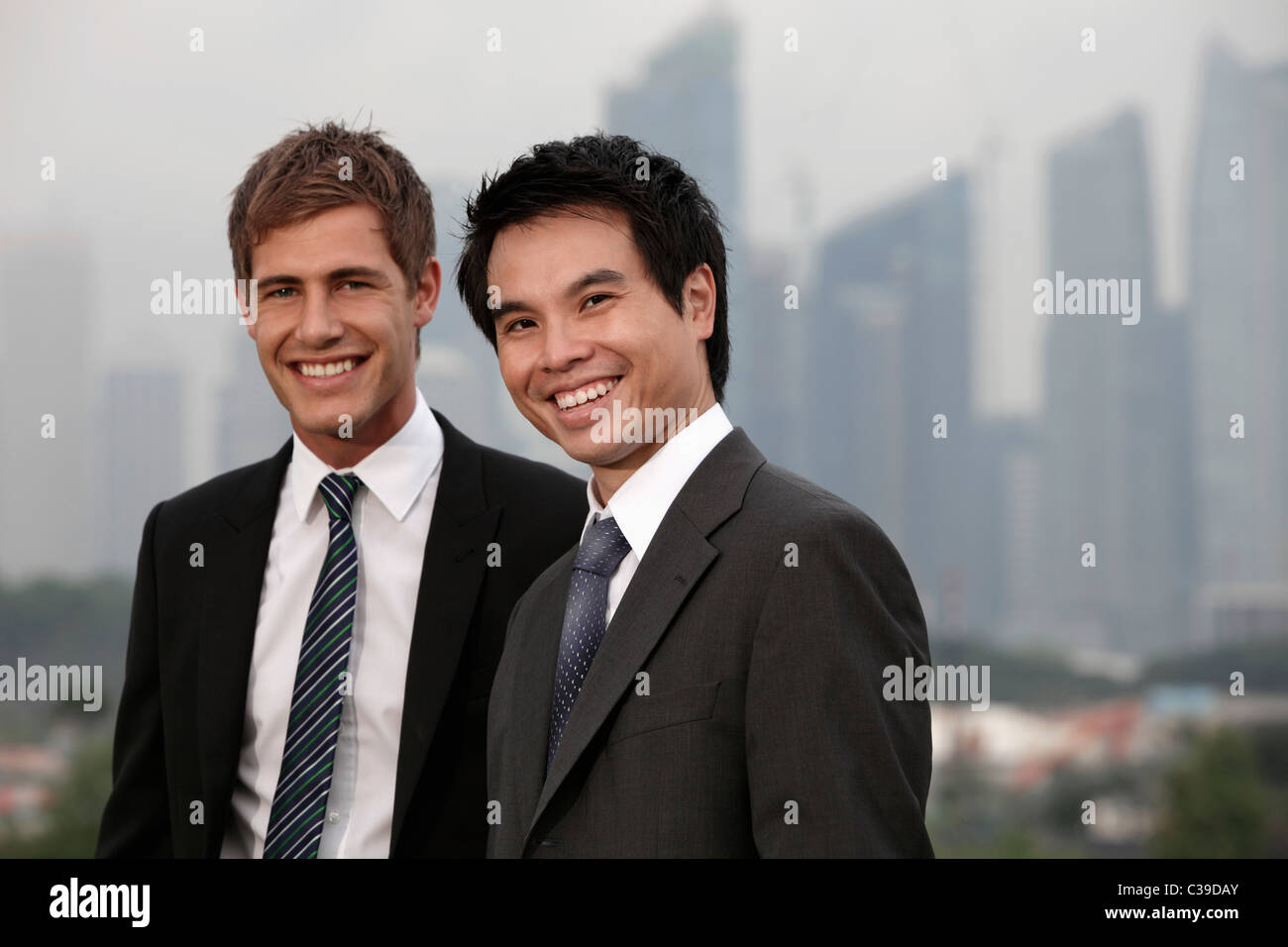 Chinese man and Caucasian man standing in front of buildings Stock ...