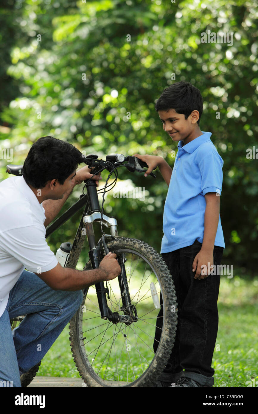 Father and son fixing bike together Stock Photo - Alamy