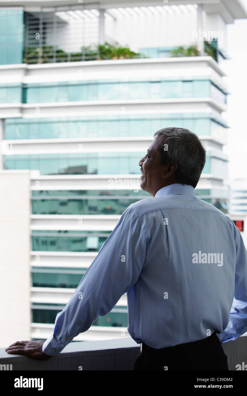 Back shot of Indian man looking at building Stock Photo - Alamy