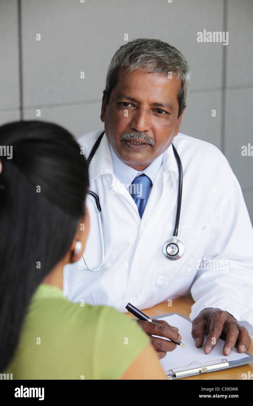 Indian doctor talking to patient Stock Photo - Alamy