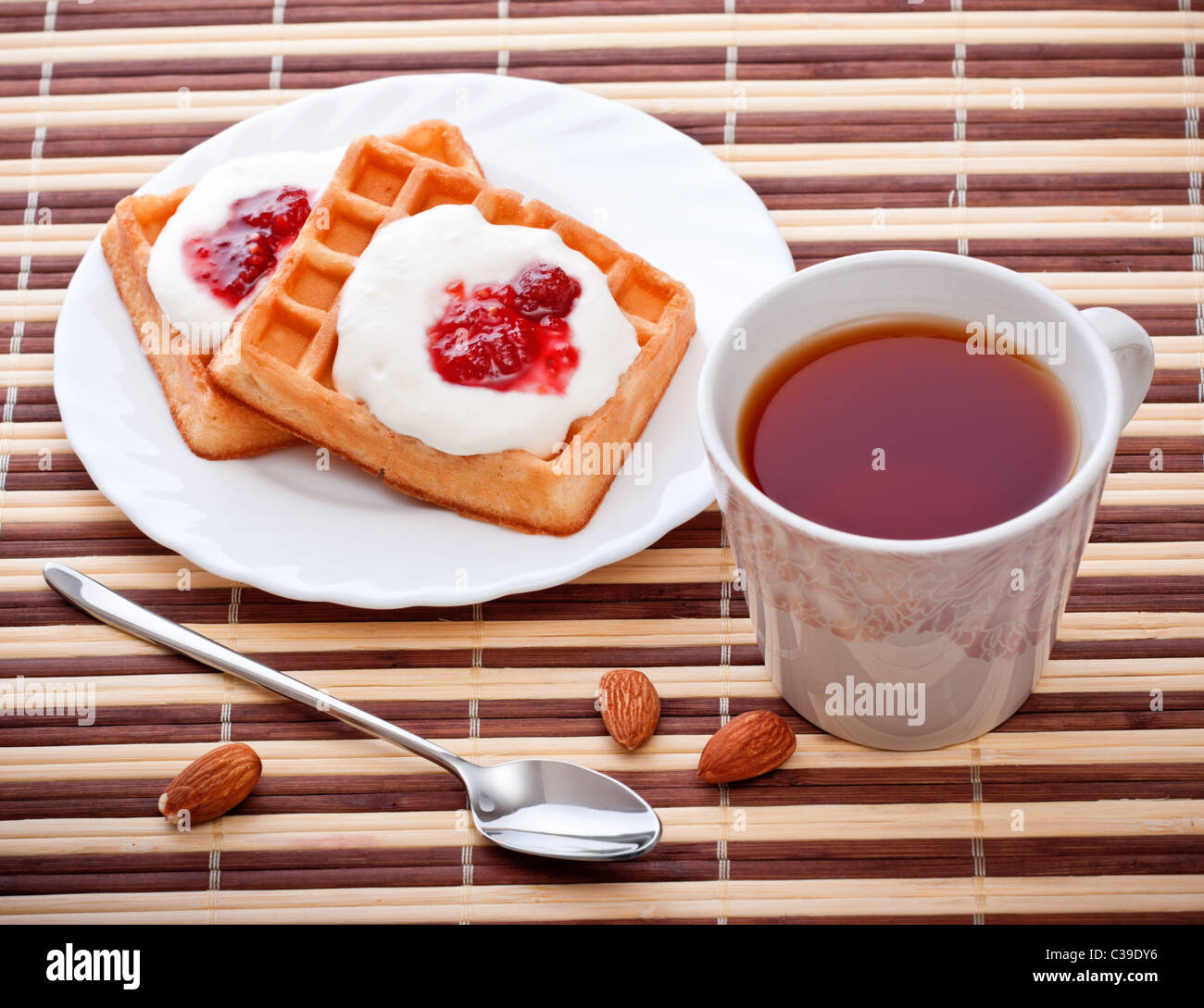 dessert with soft waffle, tea and raspberry jam Stock Photo - Alamy